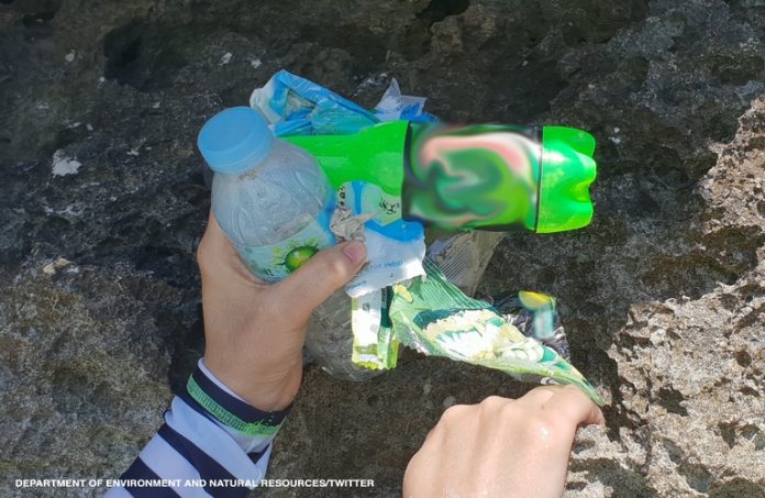 A day after tourists return to Boracay, trash found dumped on beach ...